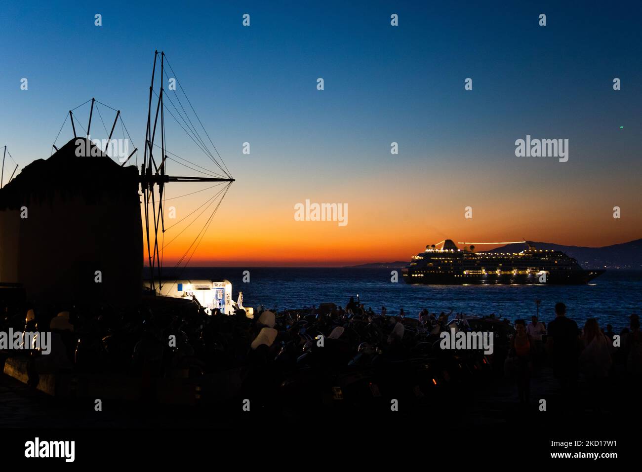 Magic hour at the iconic windmills of Mykonos island with a cruise ship ...