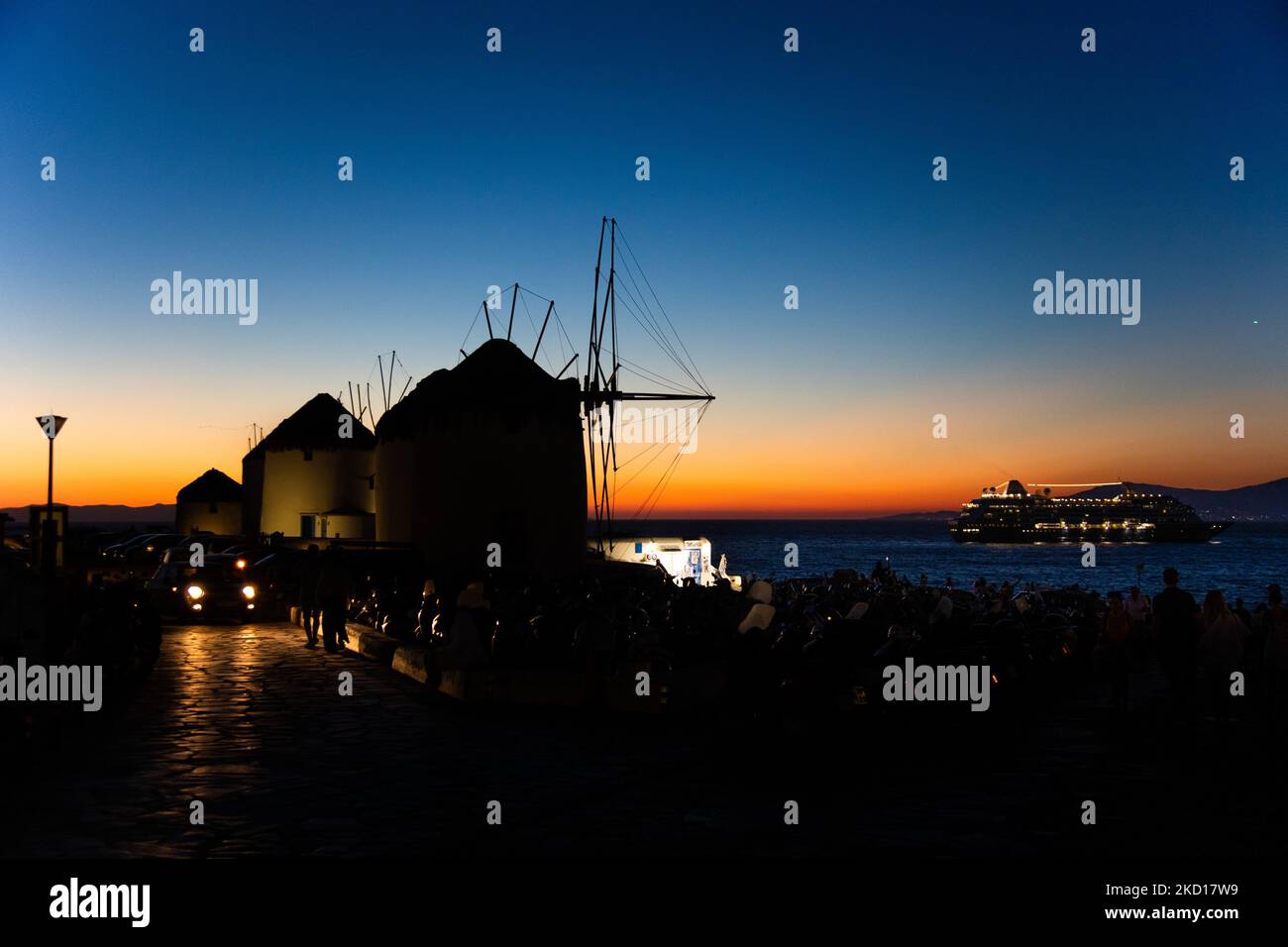 Magic hour at the iconic windmills of Mykonos island with a cruise ship ...