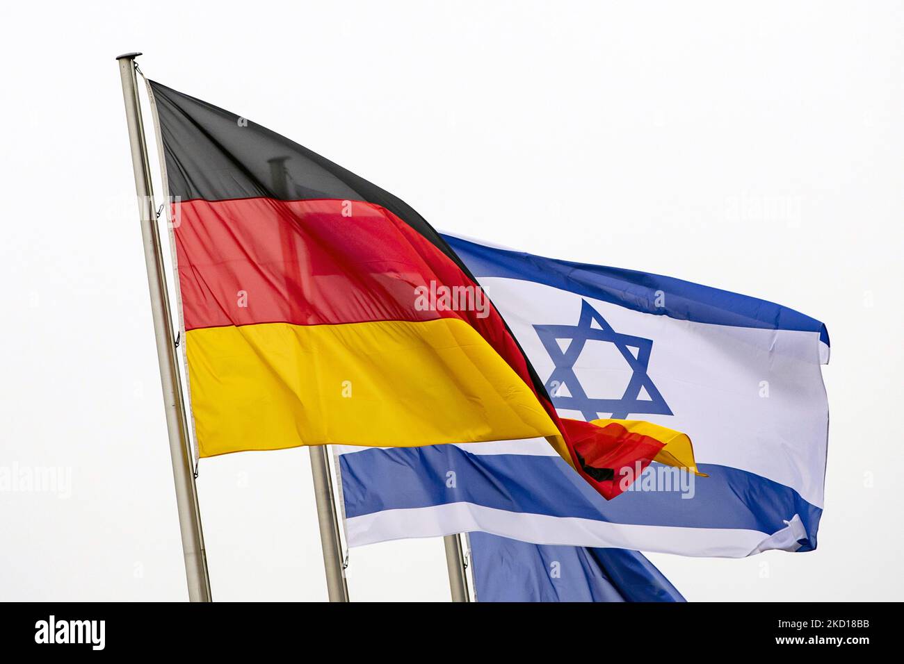 The flags of Germany and Israel fly in front of the Reichstag building ...
