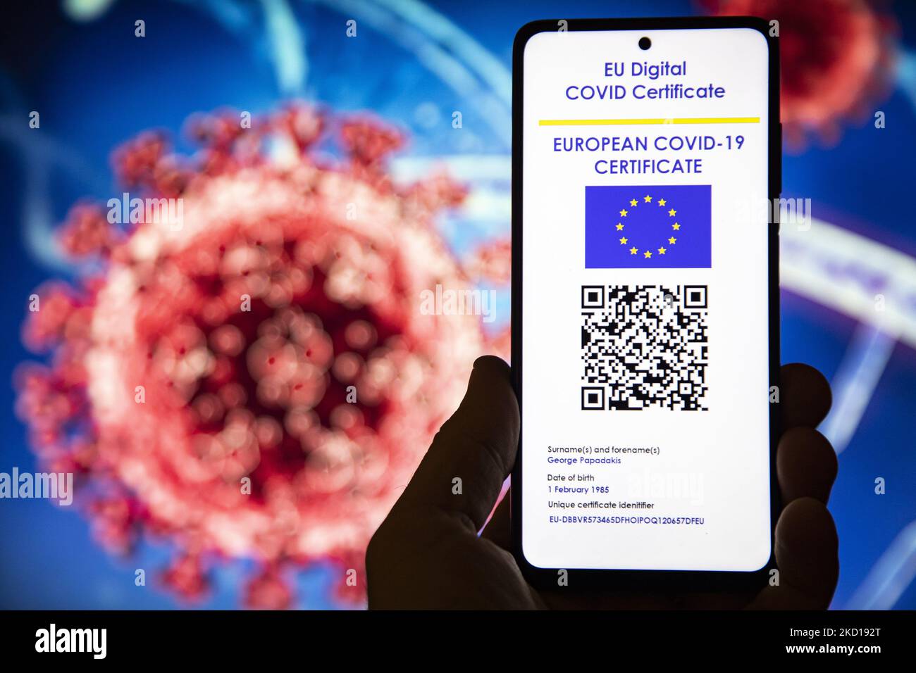 Photo illustration of a hand holding and showing the display of a ...