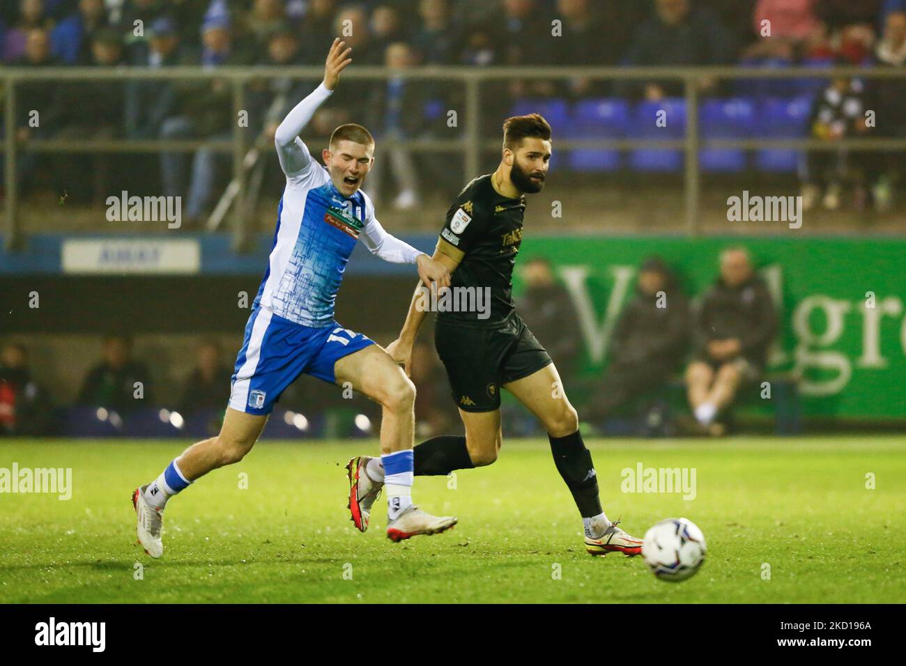 Jason Lowe of Salford City and Will Harris of Barrow in action during ...