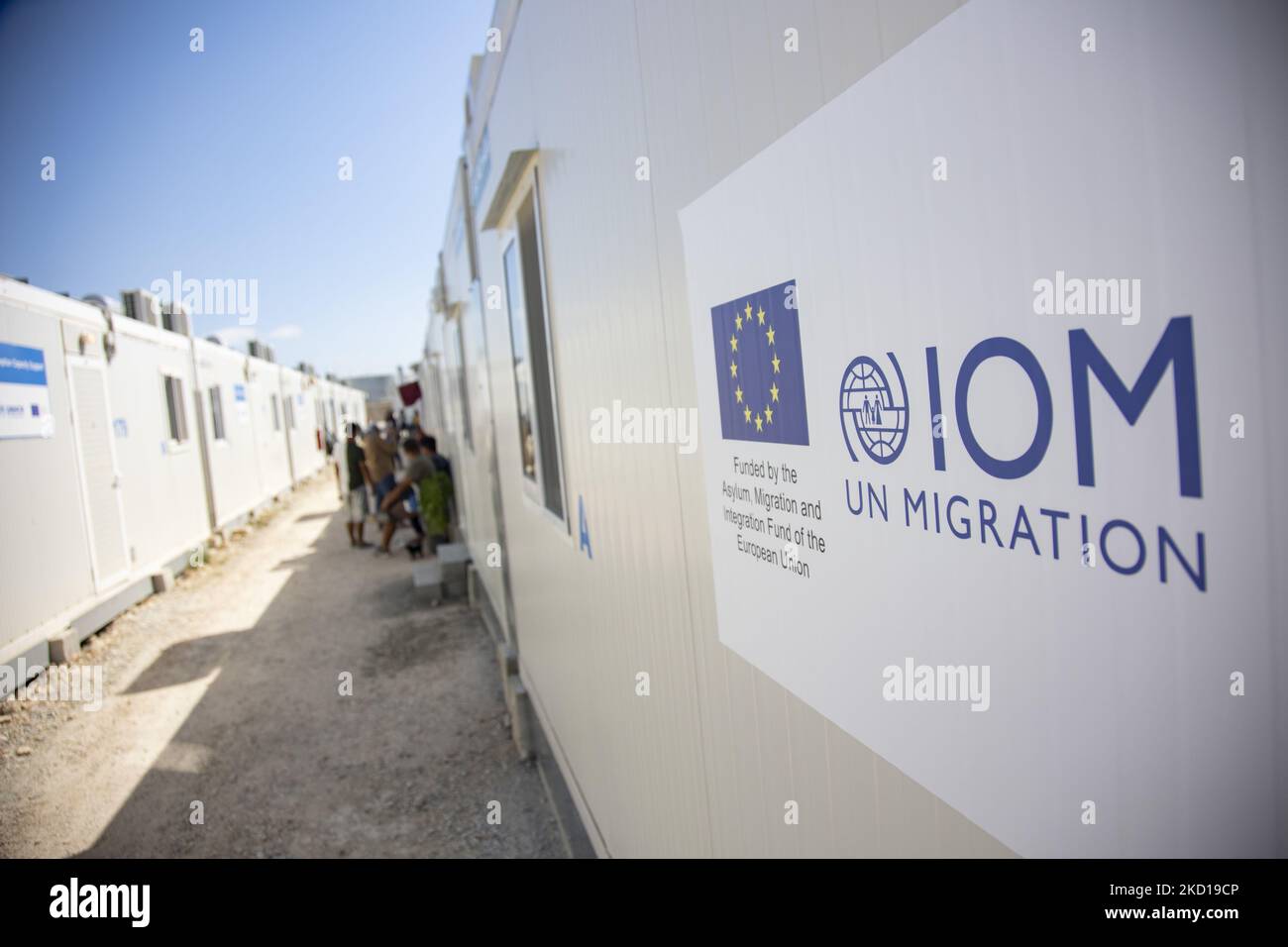 A sign with the IOM UN MIGRATION logo. Inside the new Refugee camp in ...