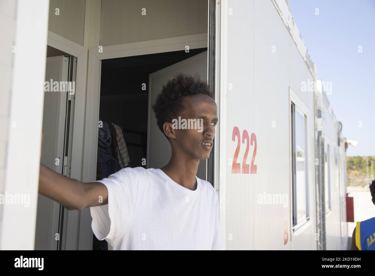Close up of a young man from Somalia at his doorstep. Inside the new ...