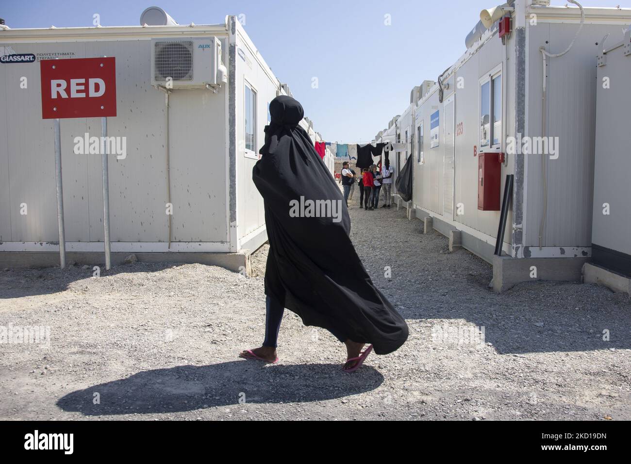 A young woman as seen walking in the camp wearing the traditional ...
