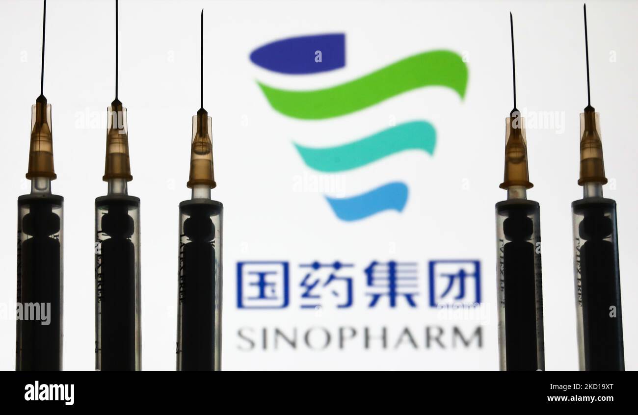 Medical syringes and Sinopharm logo displayed on a screen in the ...