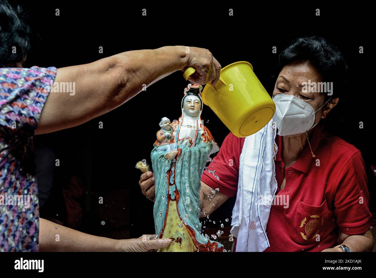 A devotees washes a statue of deities as a ritual for the upcoming ...