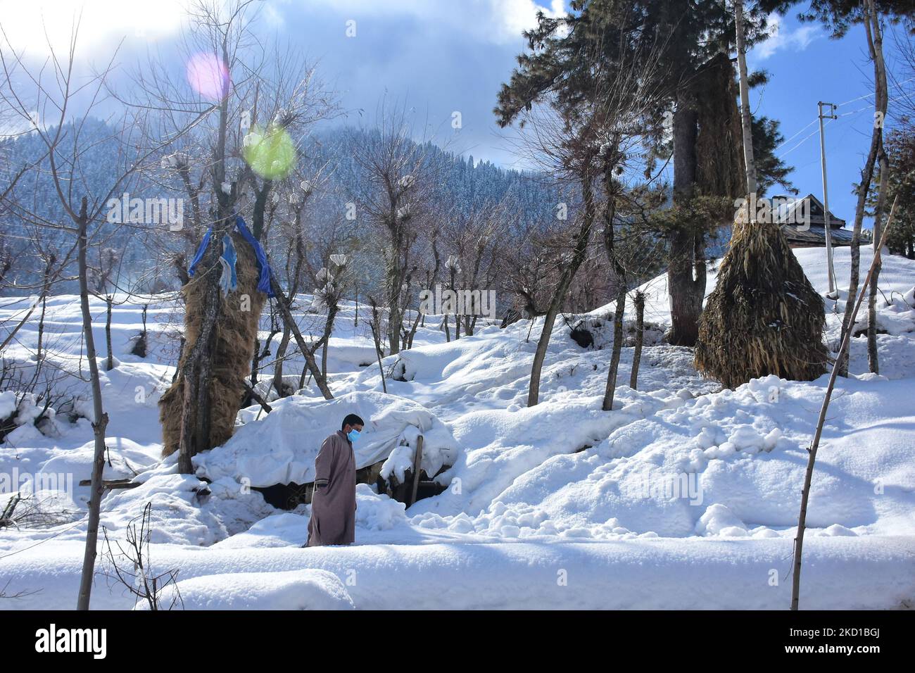 A man walks through the snow in Budgam district of Indian Administered ...