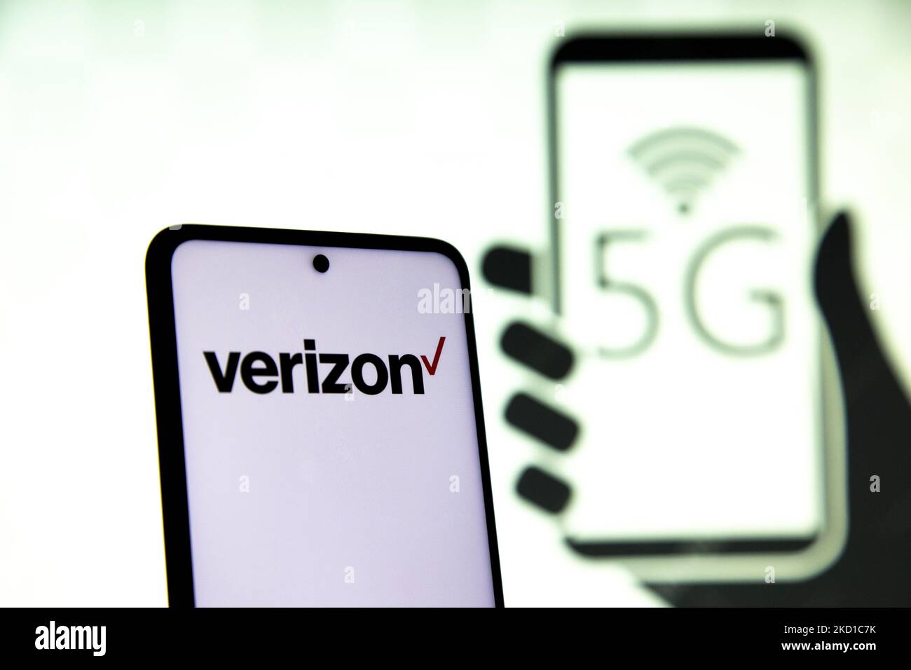 Photo illustration of a the Verizon logo and 5G signal displayed on a ...