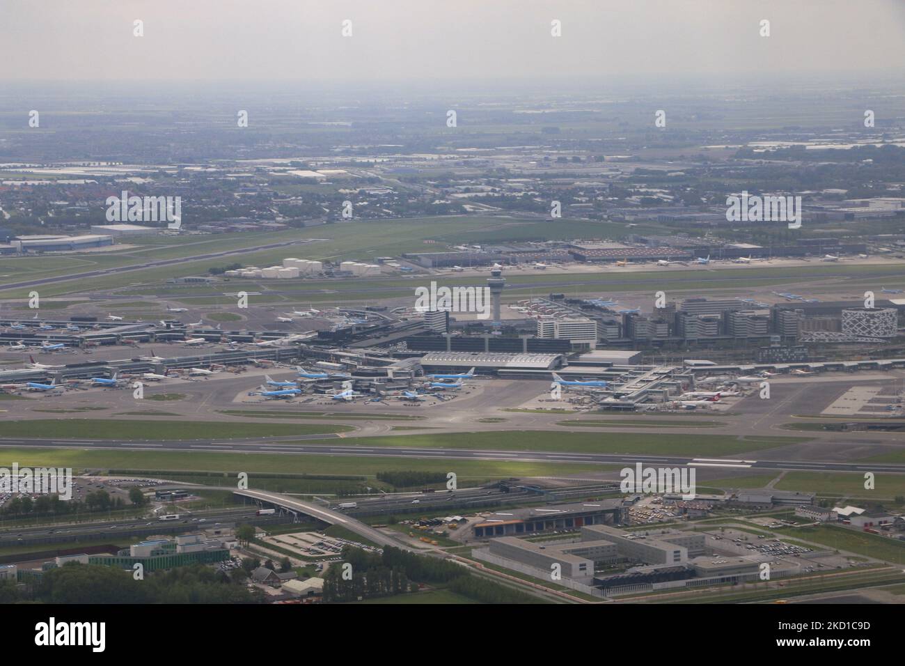The airport terminal with blue KLM jet planes and others at the gates ...