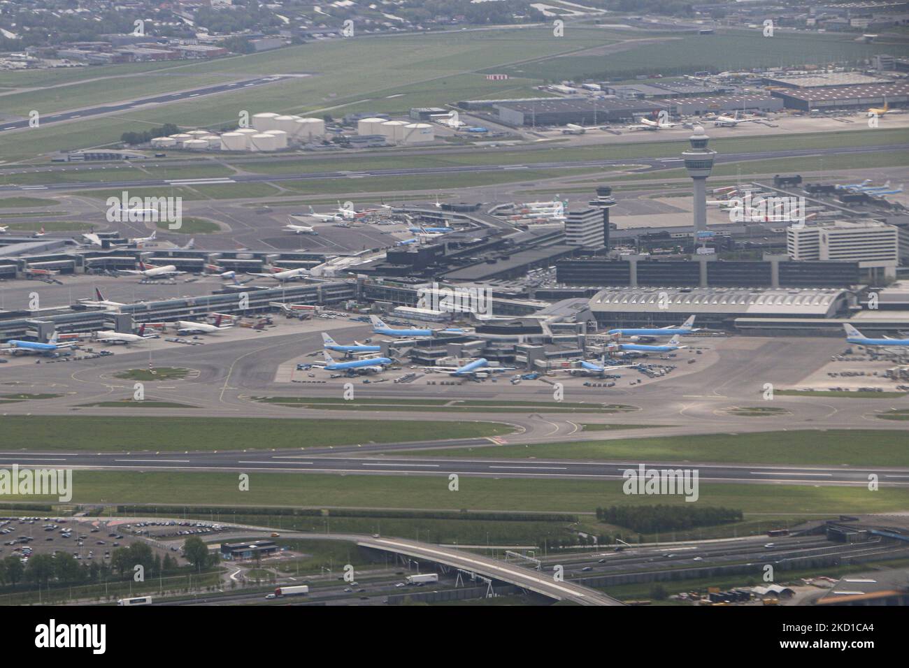 The airport terminal with blue KLM jet planes and others at the gates ...