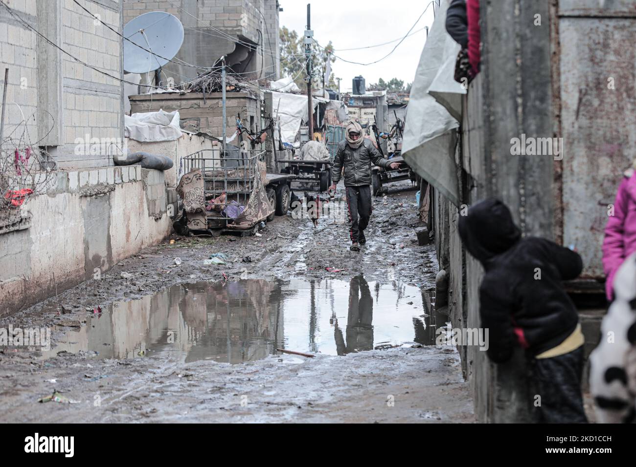 Palestinian children living in slums play in the street during cold ...