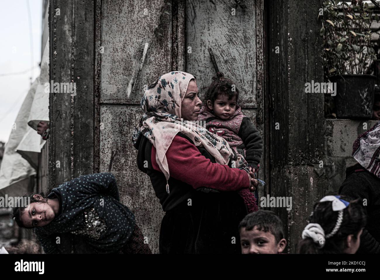 Palestinian children living in slums play in the street during cold ...