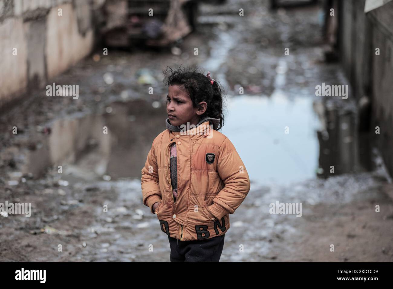 Palestinian children living in slums play in the street during cold ...