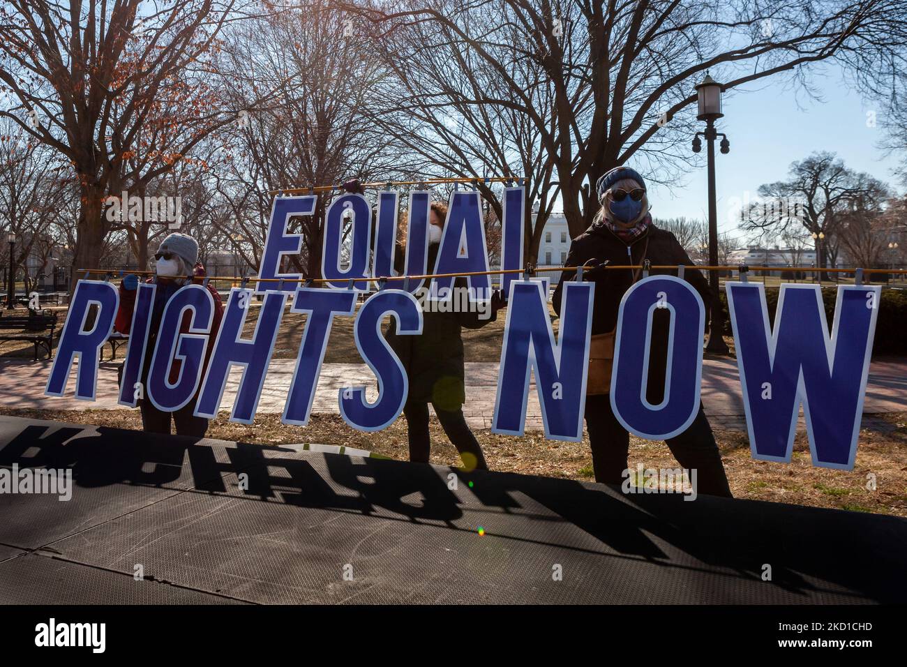 Large blue letters spell out "equal rights now" during a rally and ...