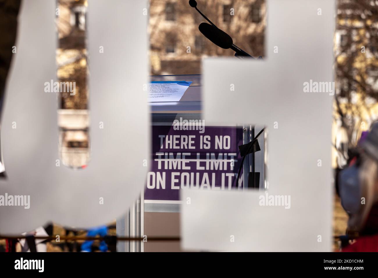 A sign is visible on the podium through letters spelling out "equal ...
