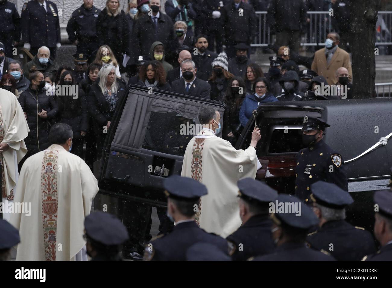 Priests bless the casket as thousands of police officers from various ...