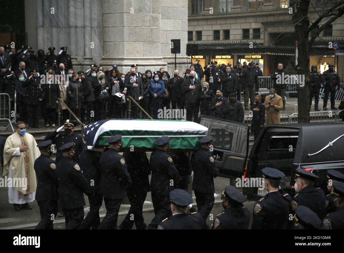 NYPD officer carry the casket of the Fallen officer as thousands of ...