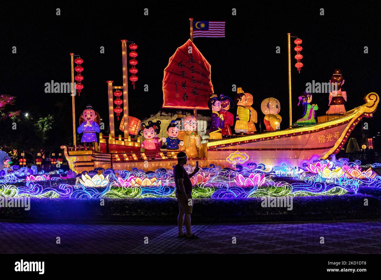A man takes a picture of the huge lantern decorations inside the Fo ...