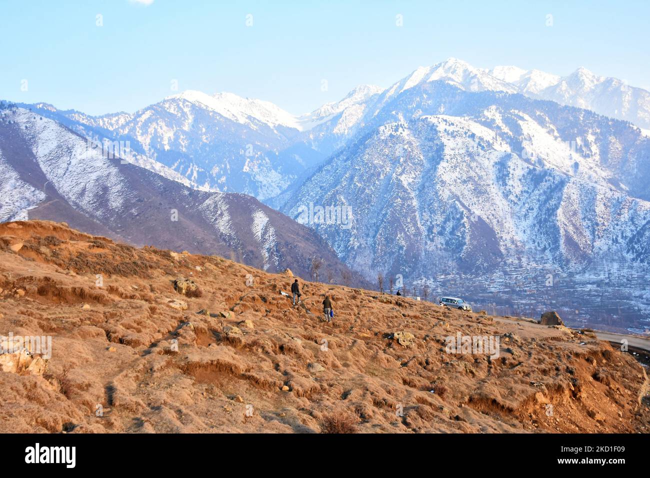 People trek on Zabarwan mountain on a cold winter day in the outskirts ...