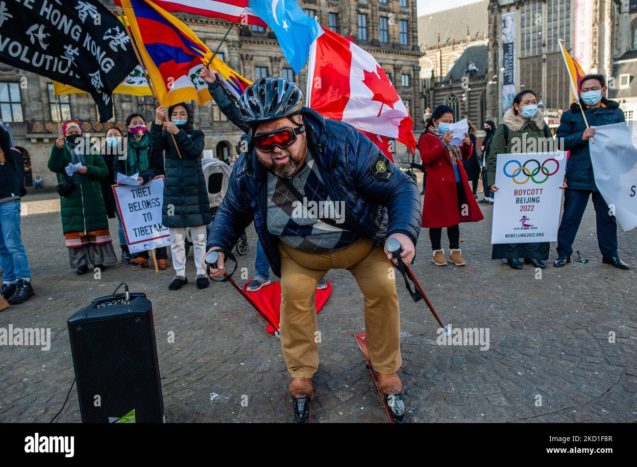 An Uyghur man is skying around the place dragging the Chinese flag behind him, during a ...