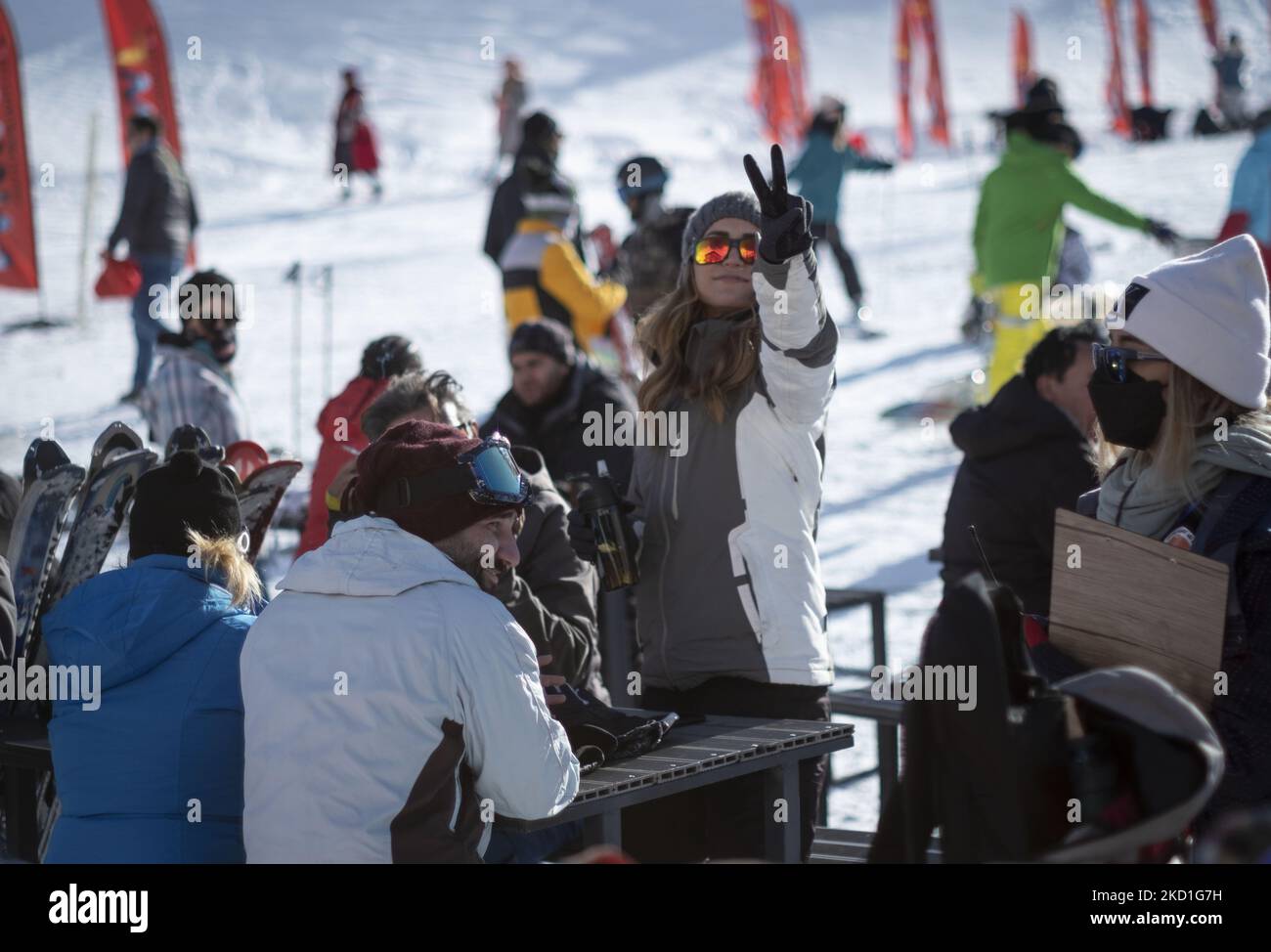 An Iranian woman wearing skiing equipment flashes a Victory sign while ...