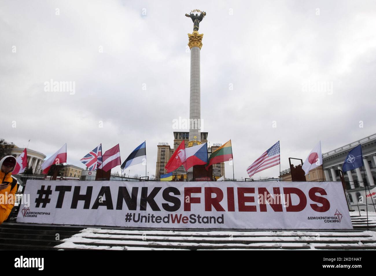A banner "Thanks friends" and flags are placed during a rally to thank ...