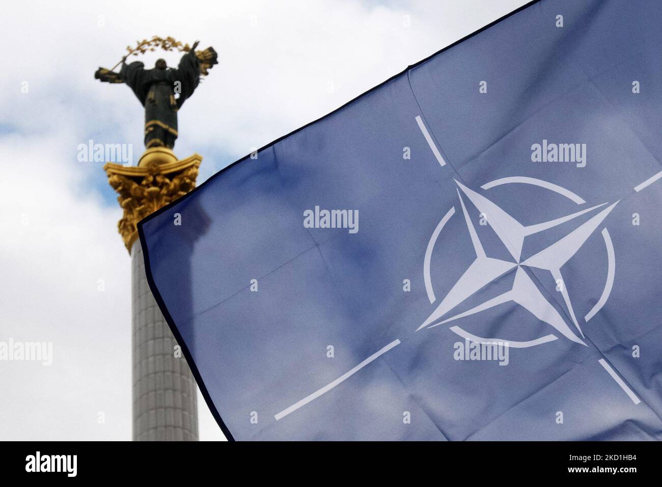 NATO flag flies in front of the Independence monument during a rally to ...
