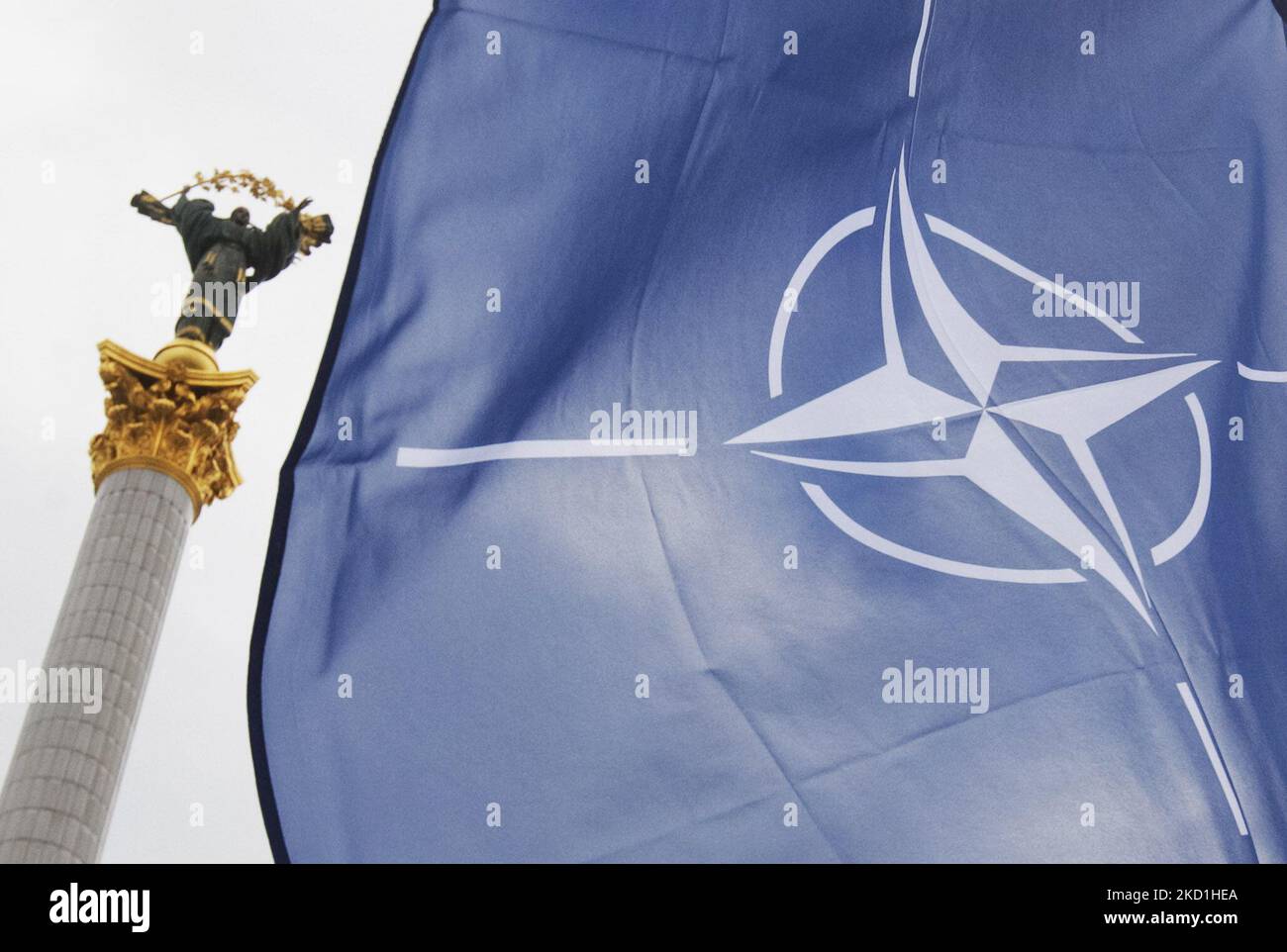 NATO flag flies in front of the Independence monument during a rally to ...
