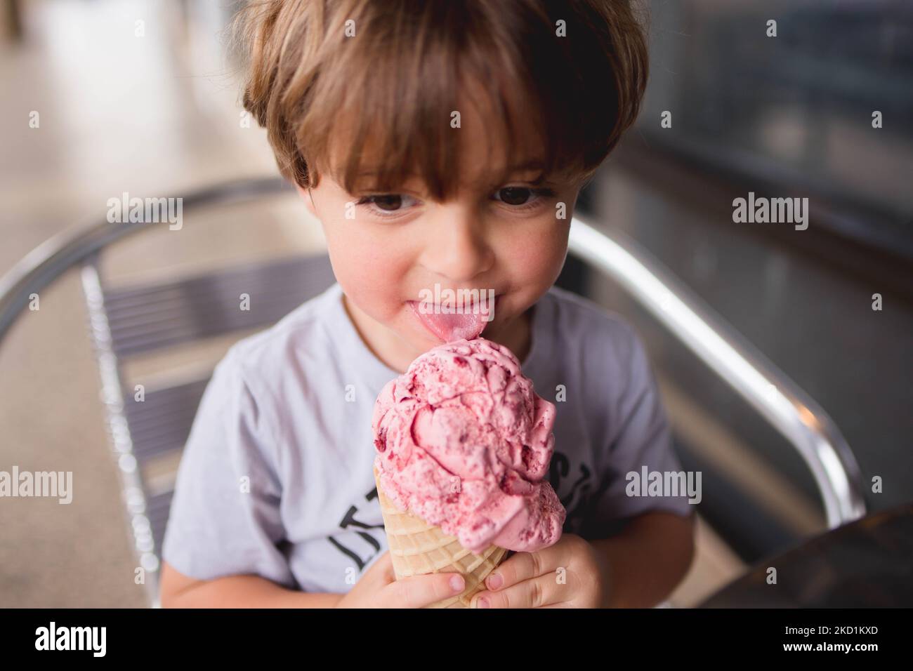A cute little Caucasian boy eating berry ice cream Stock Photo - Alamy