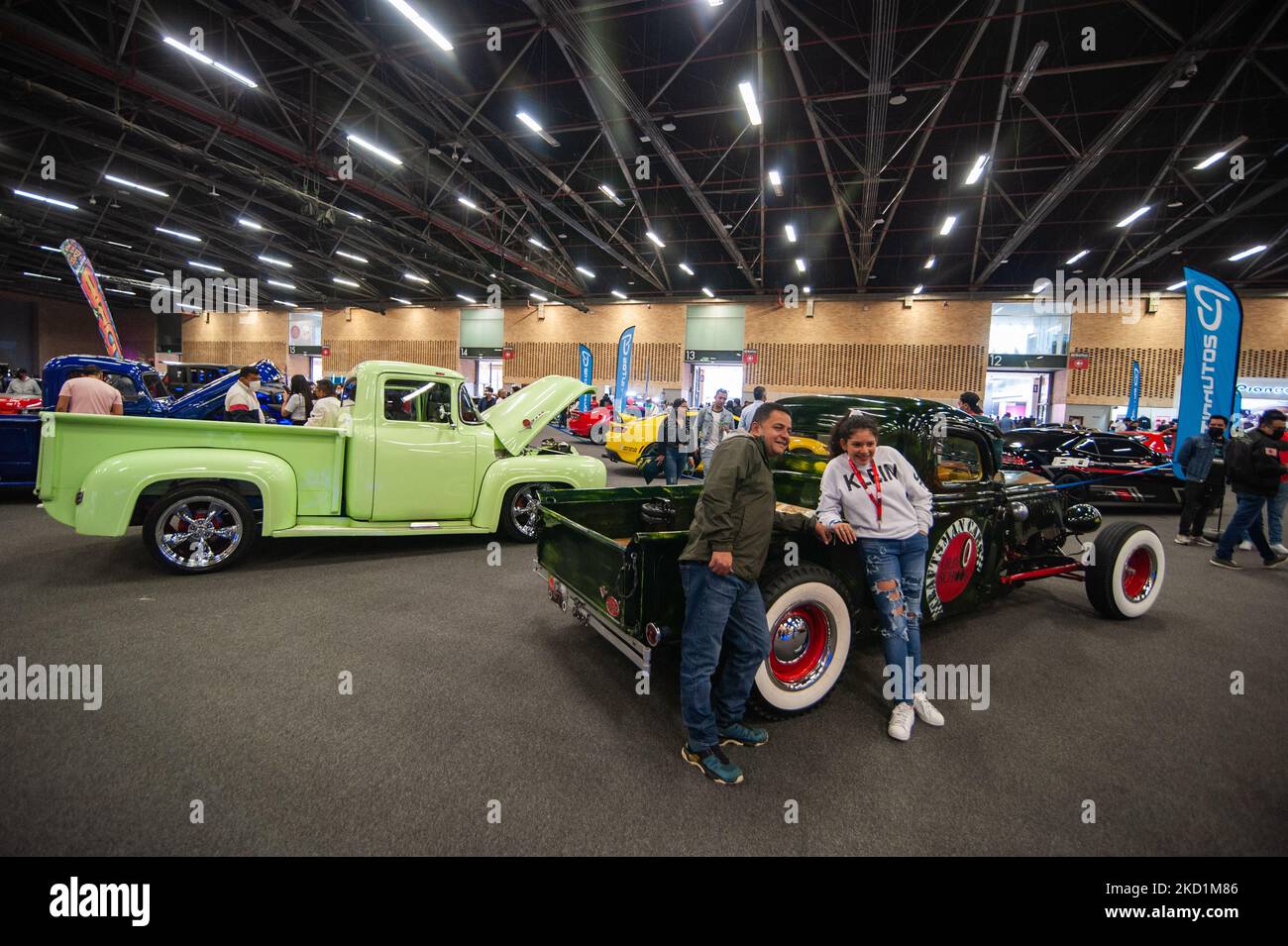 Car fans take photos with cars as they check them during the MCM Show ...