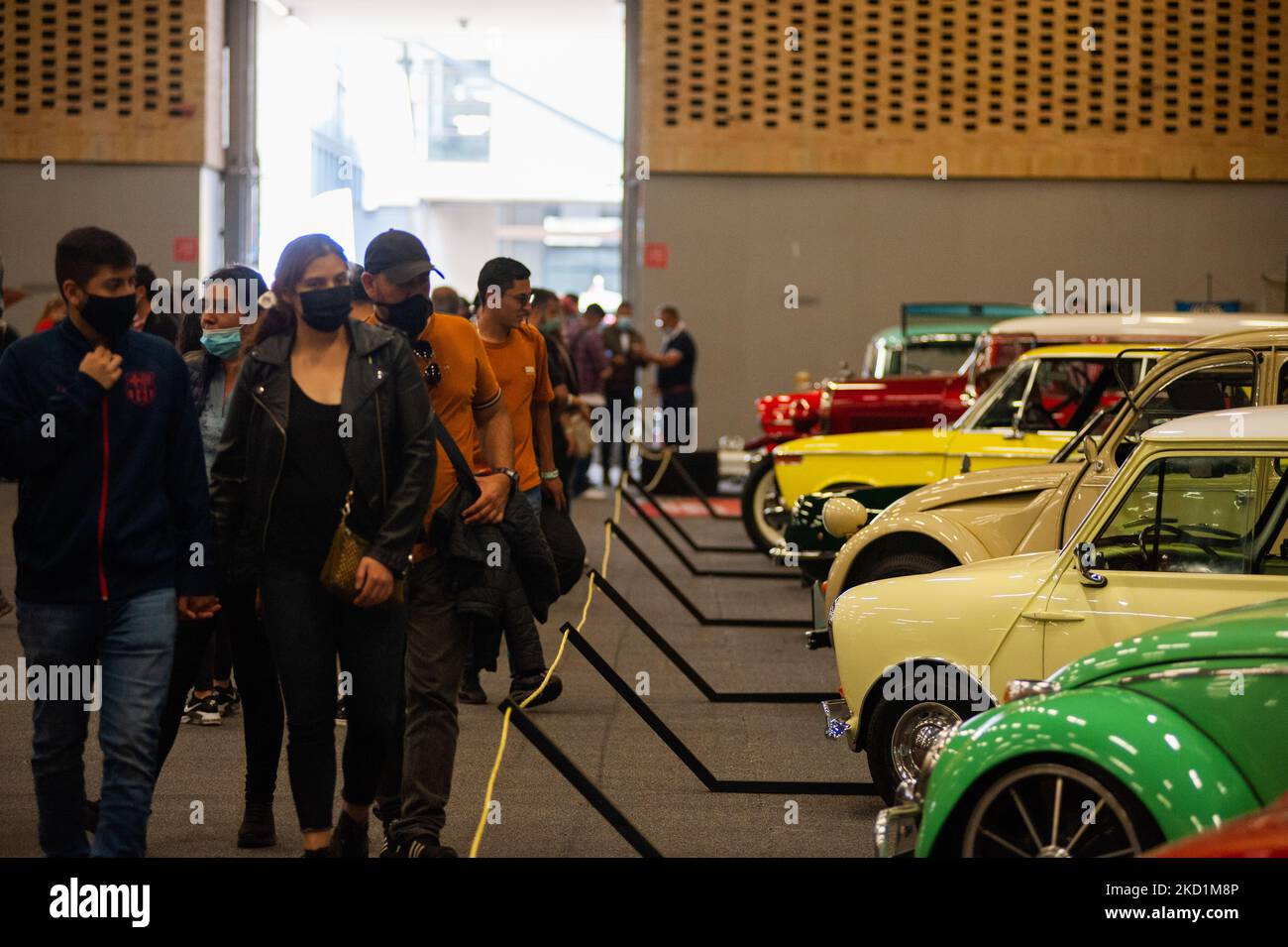 Car fans take photos with cars as they check them during the MCM Show ...