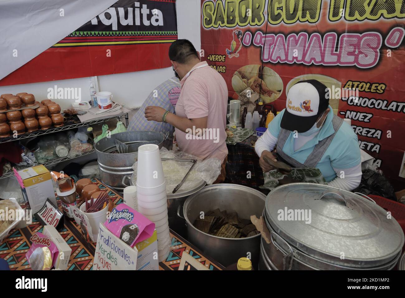 A group of people offer tamales for sale during the Tamale Fair in the ...