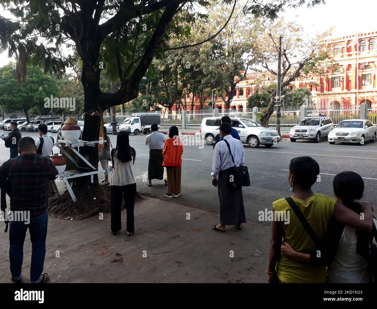 People wait for a bus after the silent strike against the military coup ...