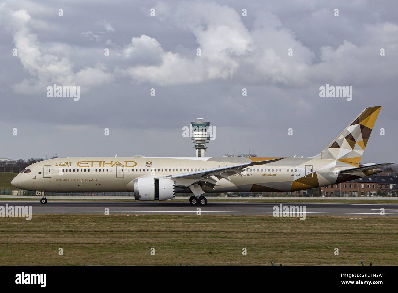 The Etihad Dreamliner as seen on the runway with the control tower and ...