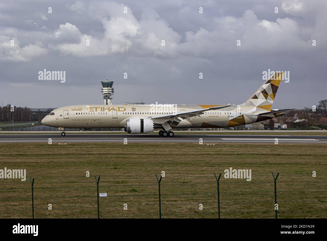 The Etihad Dreamliner as seen on the runway with the control tower and ...