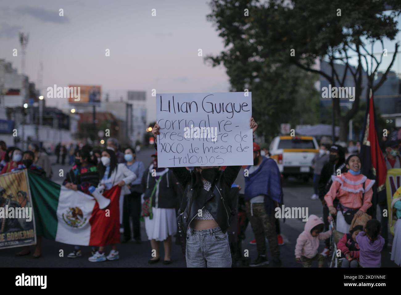A resident of the town of Xoco shows a sign that reads "Lilian Guigue ...