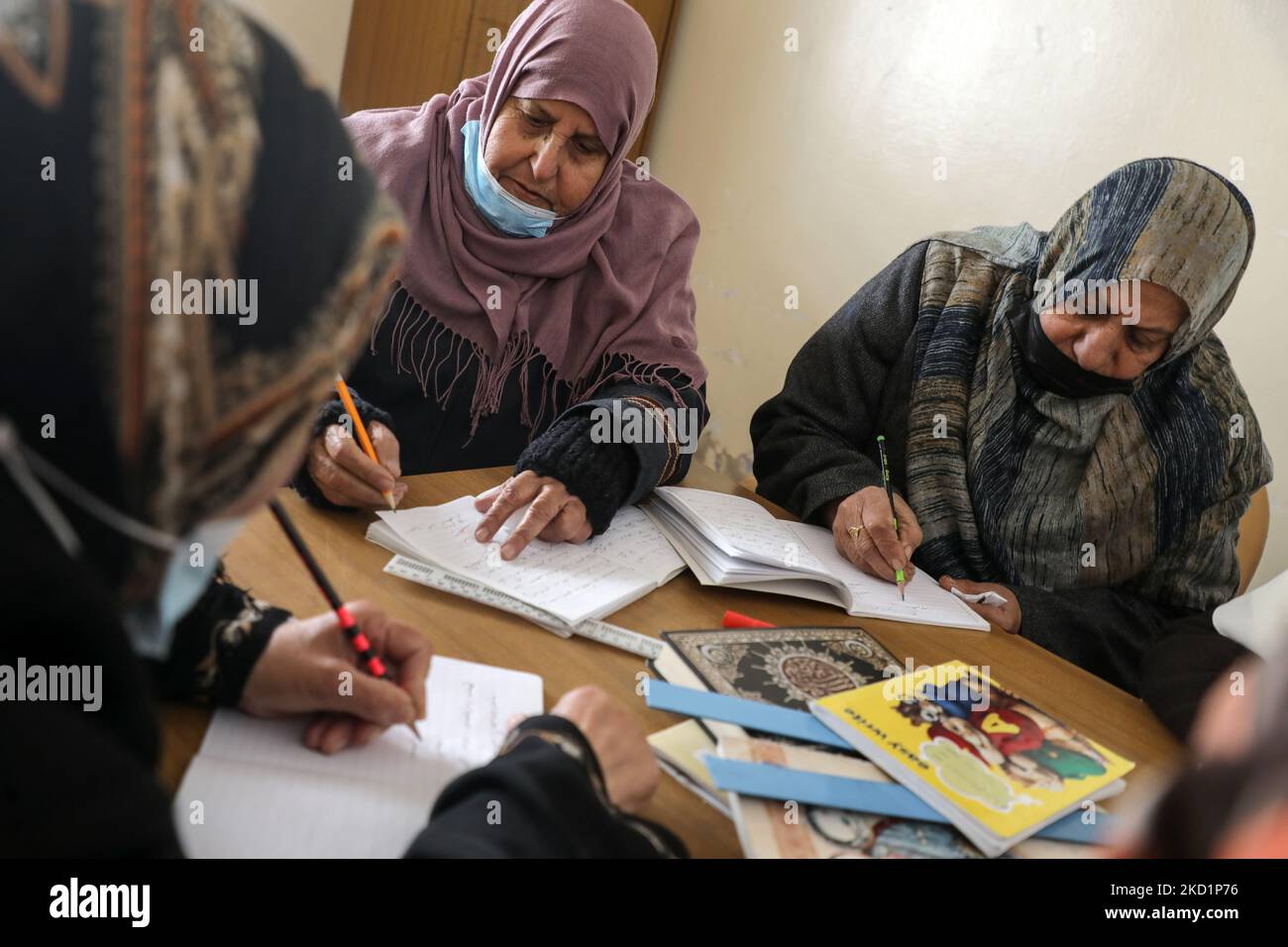 Elderly Palestinian women receive literacy lessons inside the Aged Care ...