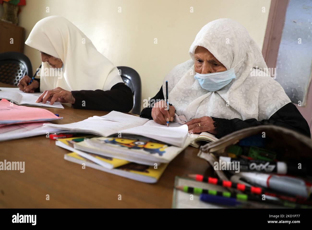 Elderly Palestinian women receive literacy lessons inside the Aged Care ...