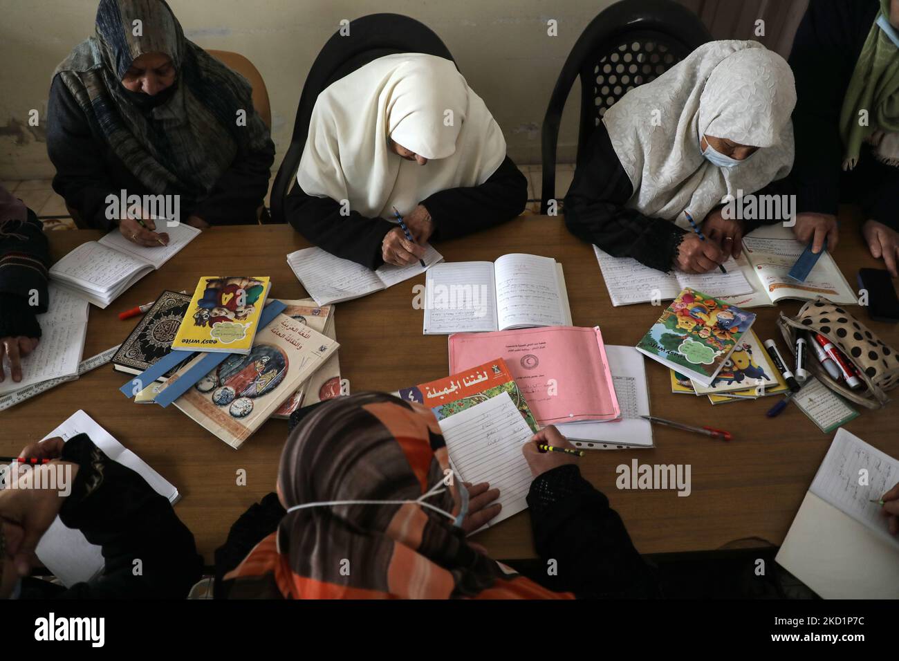Elderly Palestinian women receive literacy lessons inside the Aged Care ...