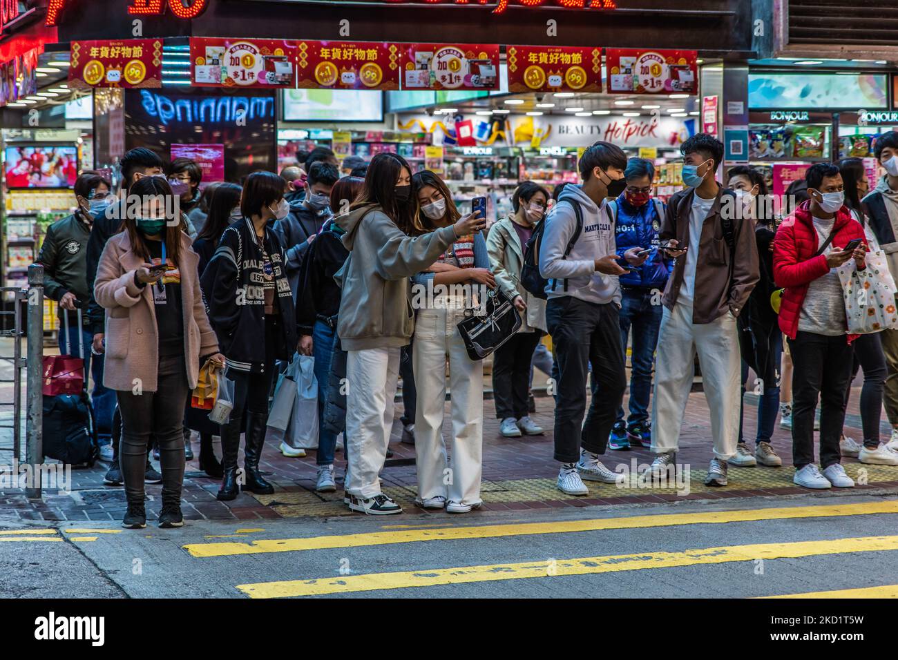 Hong Kong, China, 2 Feb 2022, People wait at a crossing on Sai Yeung ...