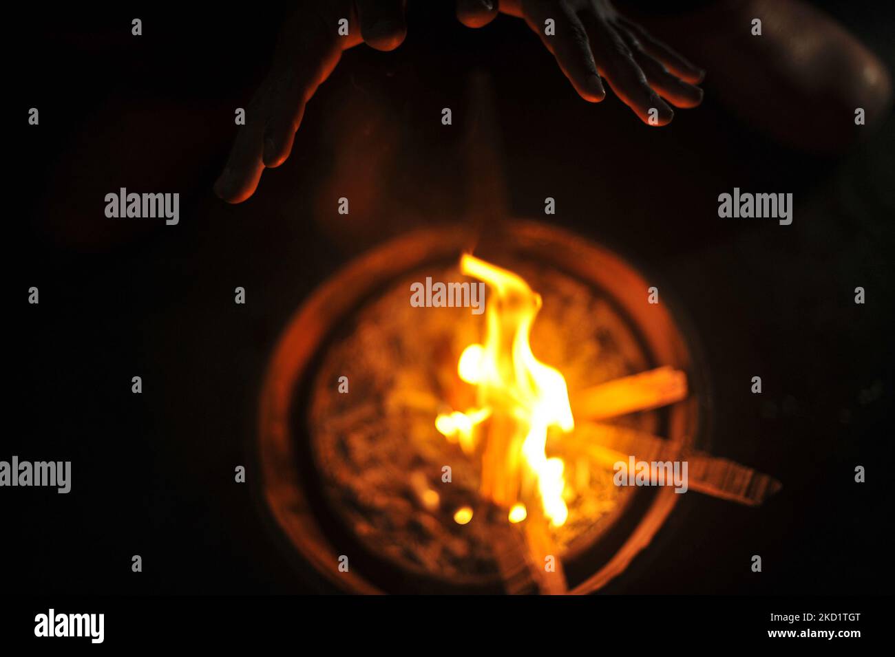 Nepalese people keep warm themselves by making fire during cold weather ...