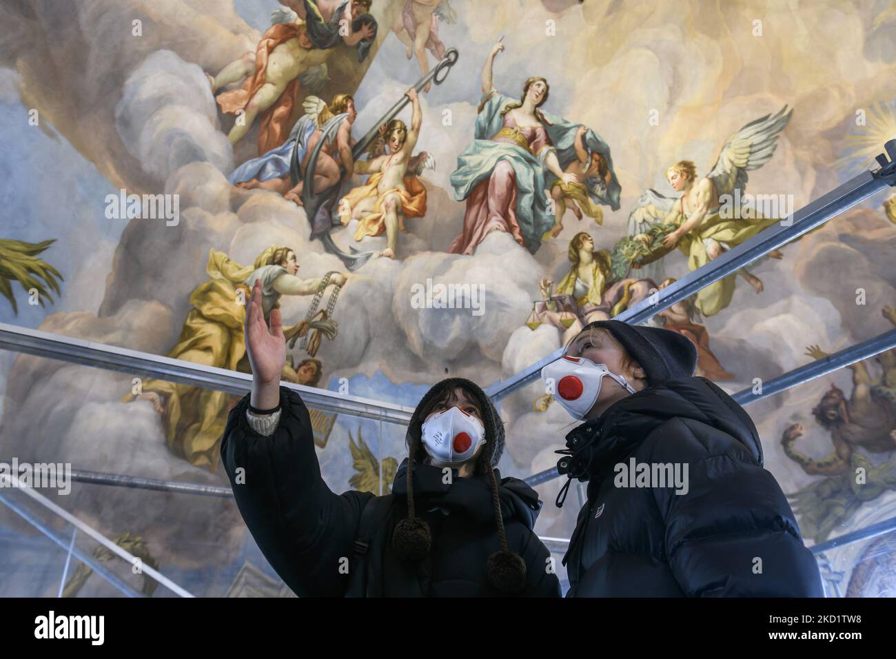 Visitors in protective masks against Covid-19 infection look the ...