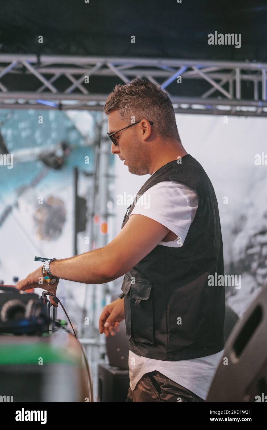 A male DJ on the stage during the electronic music festival ...