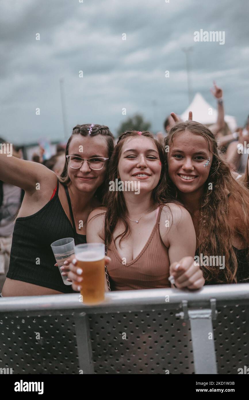 A group of young attractive females smiling during the electronic music ...