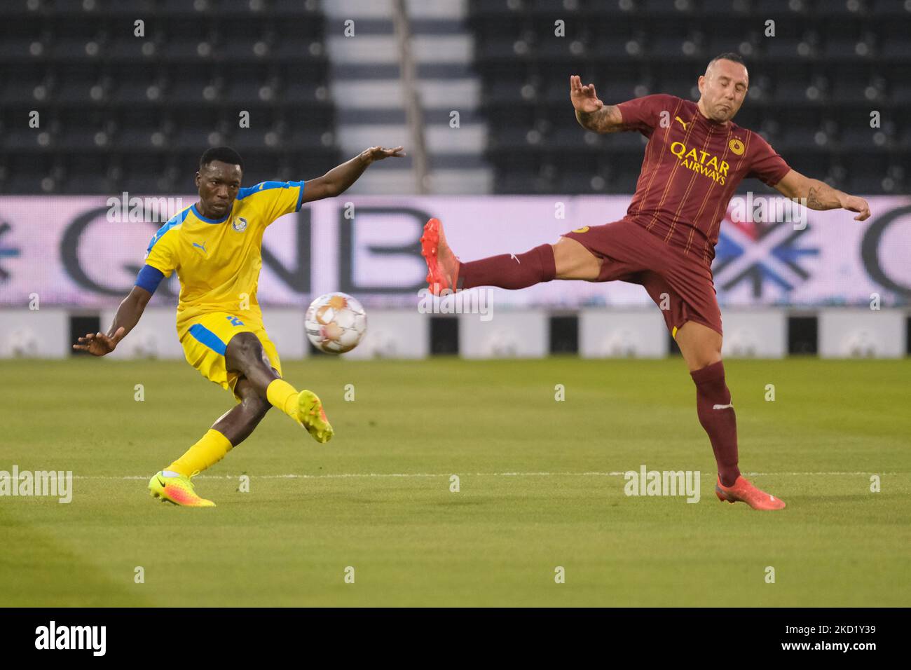 Saeed Alhaj Essa (2) of Al Gharafa clears the ball as Santi Cazorla (19 ...