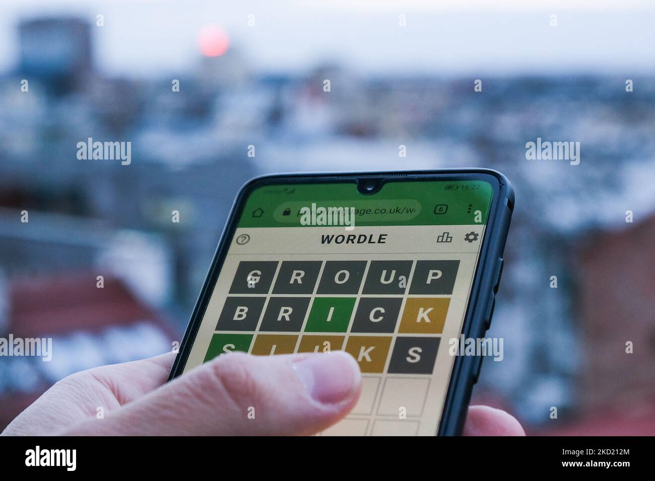 Wordle game displayed on a phone screen is seen in this illustration ...