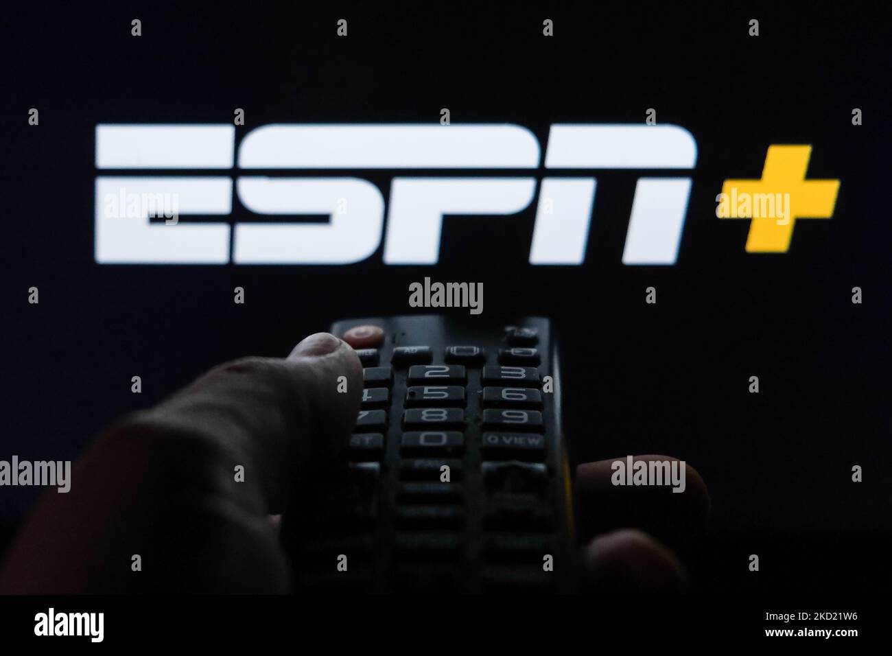 TV remote control is seen with ESPN+ logo displayed on a screen in this ...