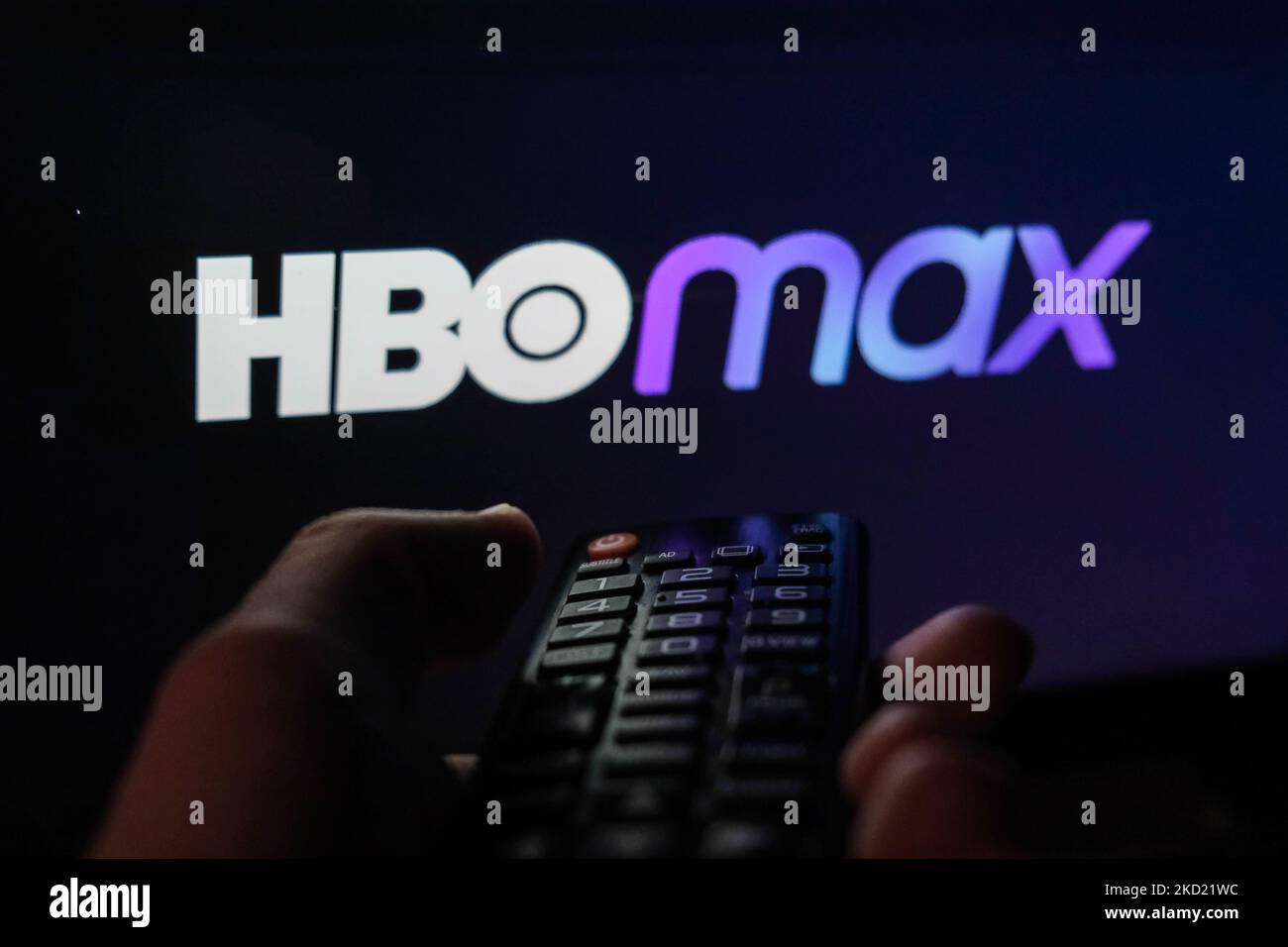 TV remote control is seen with HBO Max logo displayed on a screen in ...