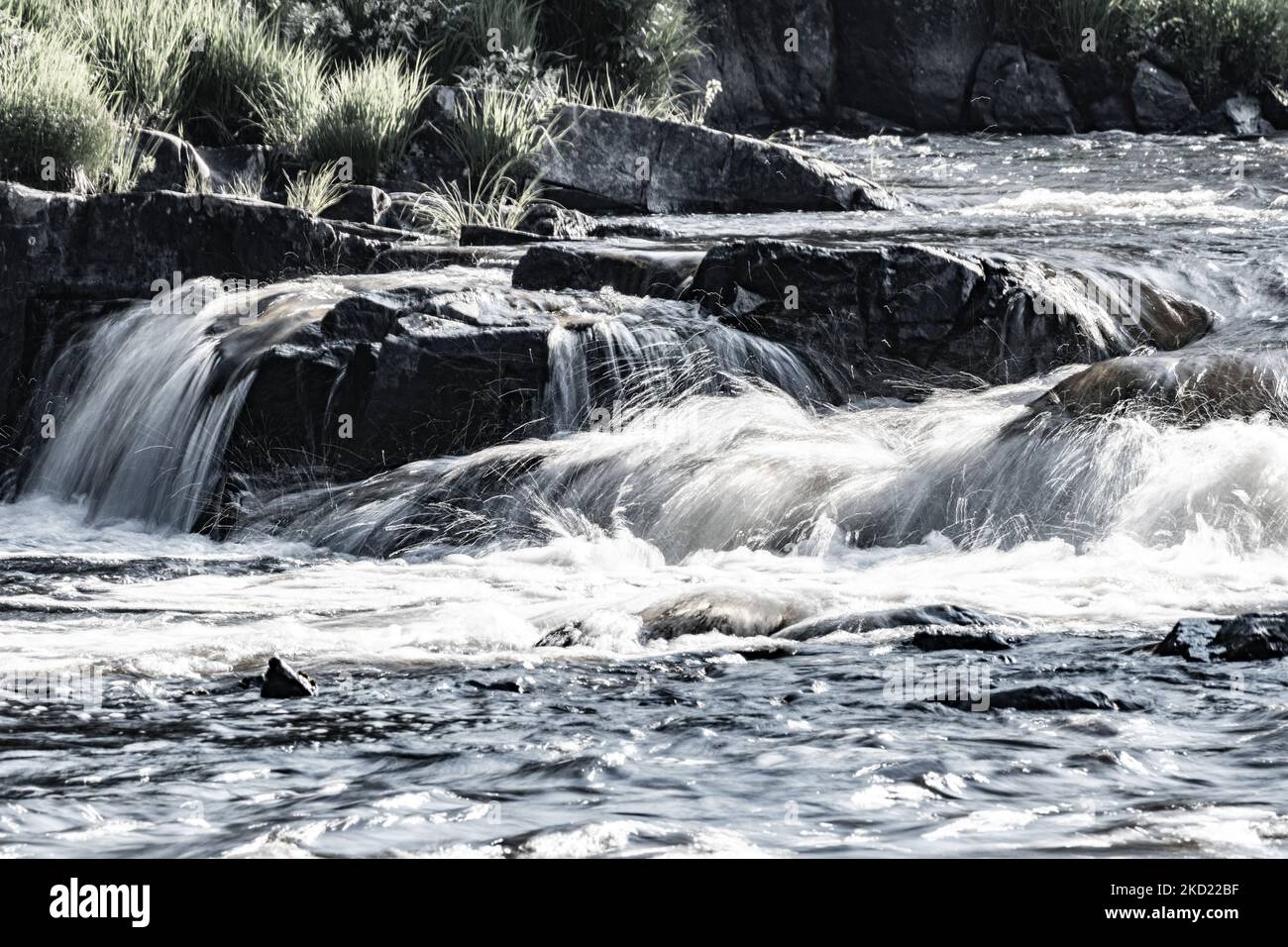 A scenery of a river flowing through the rocks Stock Photo - Alamy