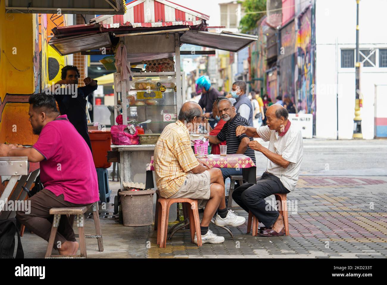 Some local people having breakfast at a stall at the Seremban Street ...